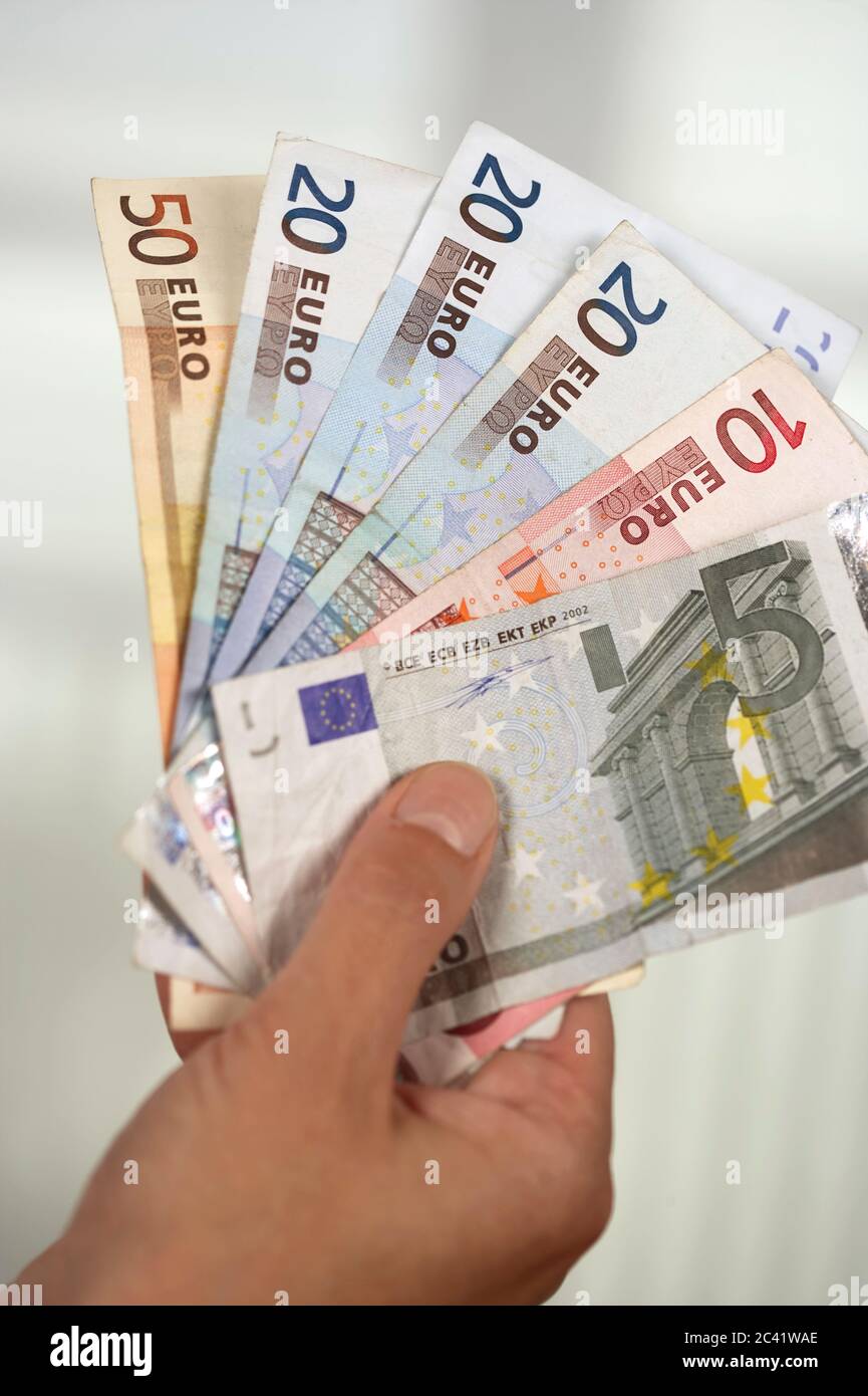 Hand holds euro banknotes - finance - wealth Stock Photo - Alamy