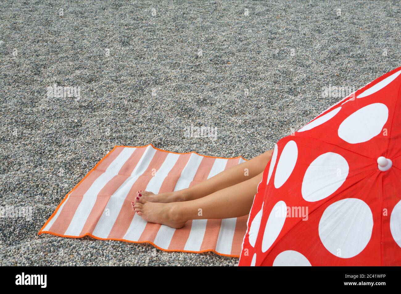 Legs of a woman on a beach sheet Stock Photo - Alamy