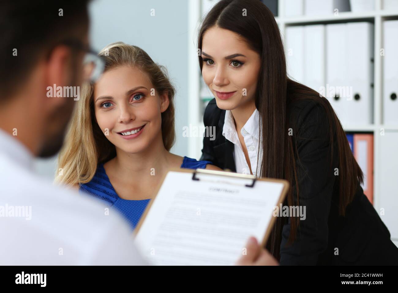 Two young woman working with papers hi-res stock photography and images ...
