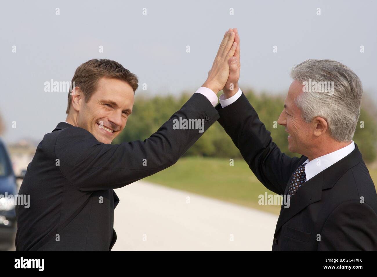 Two businessmen cheer Stock Photo - Alamy