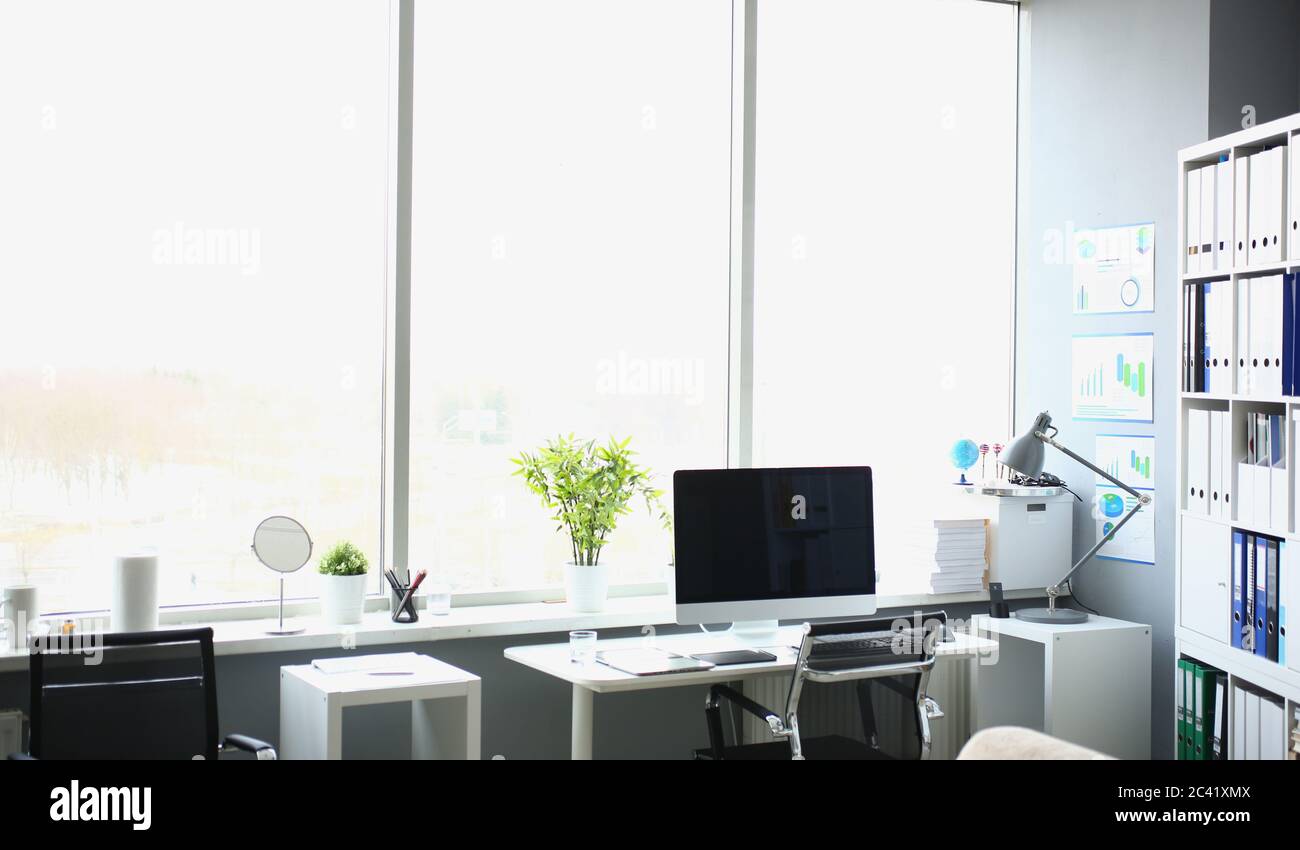 Interior of workplace with table, computer and large window Stock Photo ...