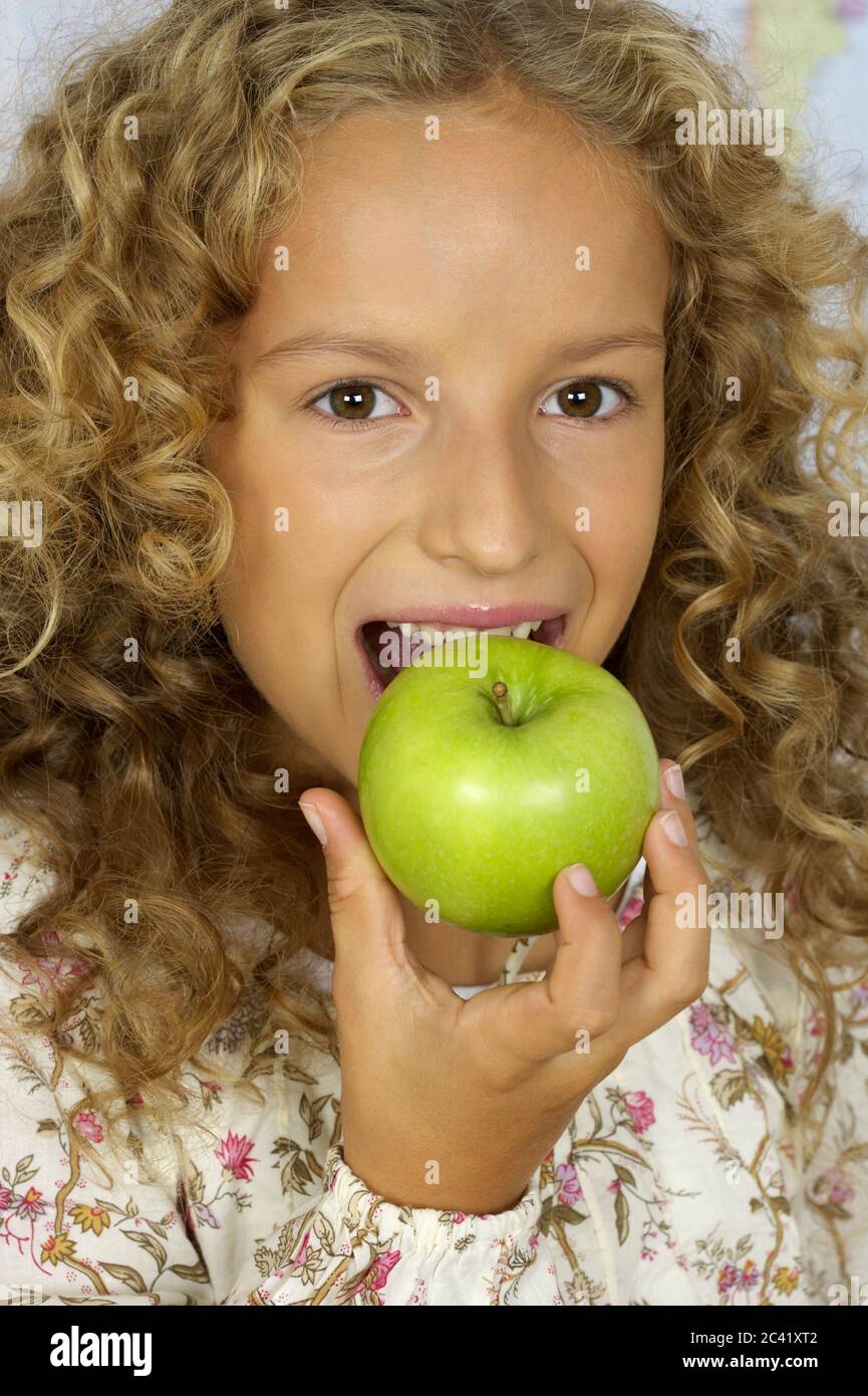 Girl bites an apple Stock Photo - Alamy