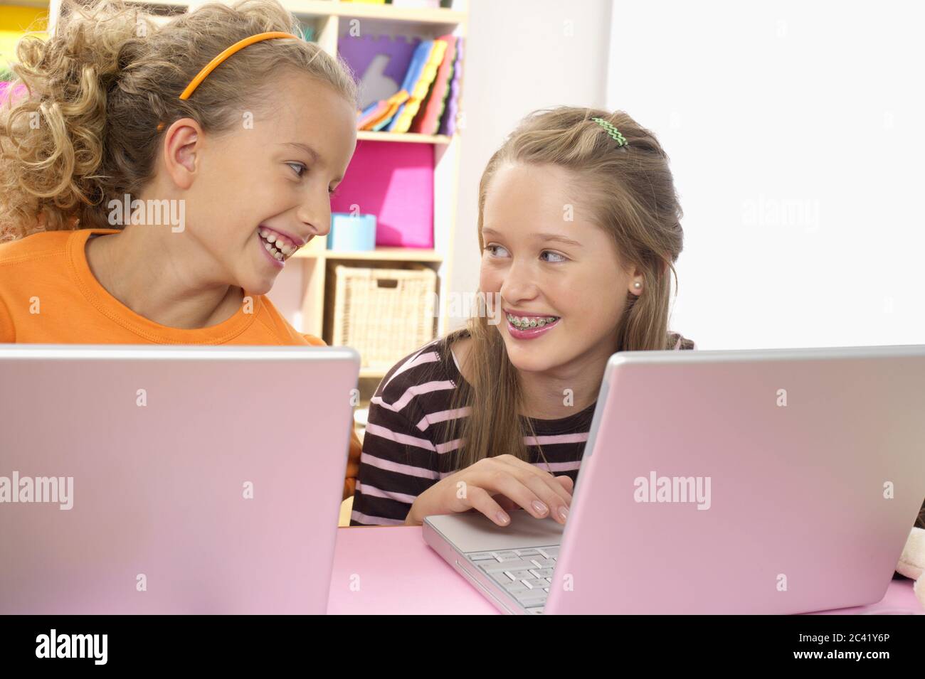 Two girls are working on laptops Stock Photo - Alamy
