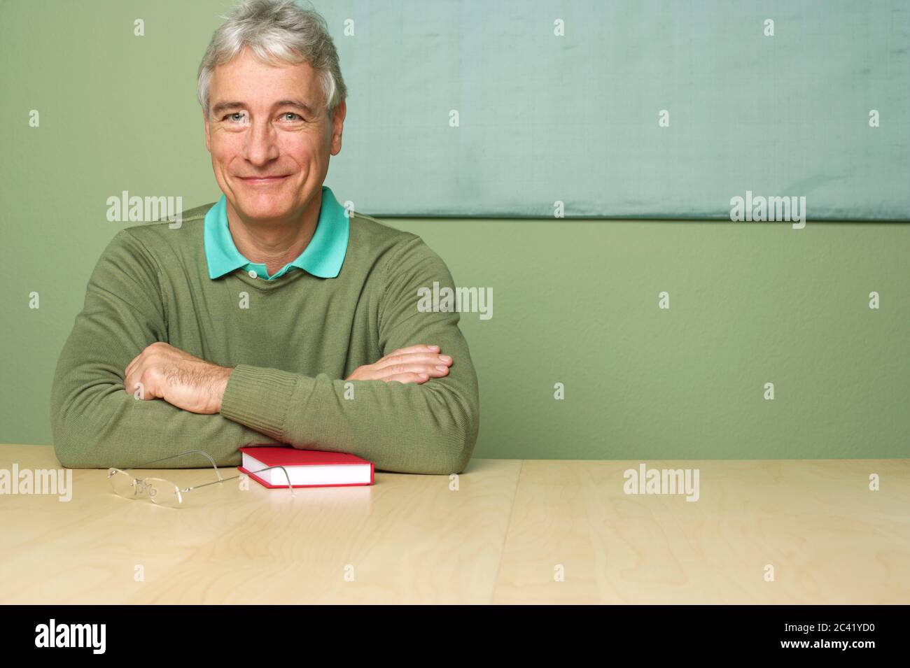 Man smiles looking camera sitting hi-res stock photography and images ...