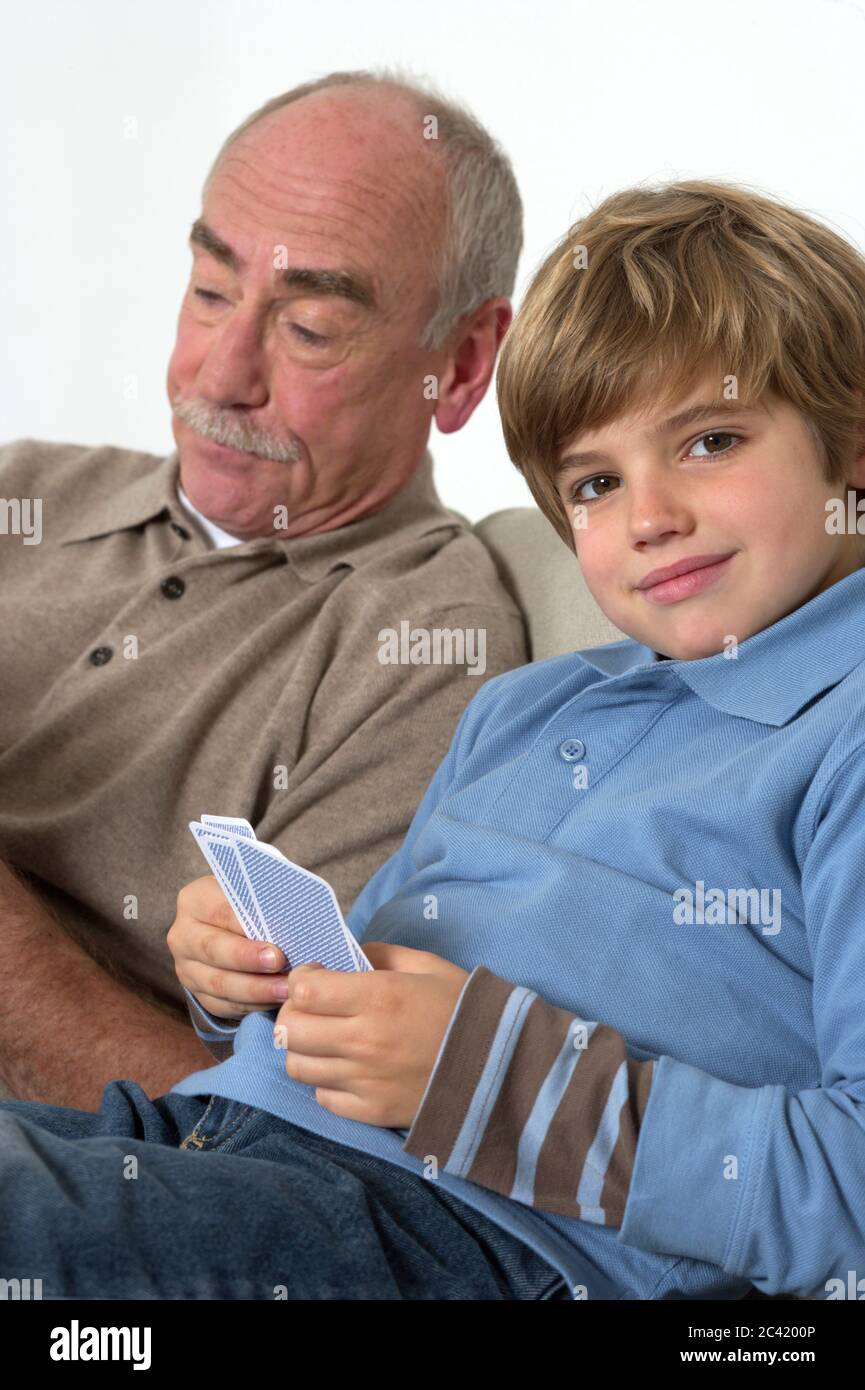 Grandpa and grandson play cards Stock Photo - Alamy