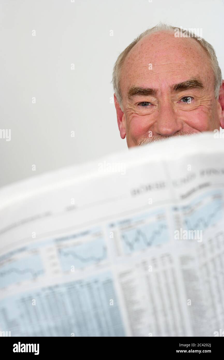 Old man reads newspaper Stock Photo - Alamy