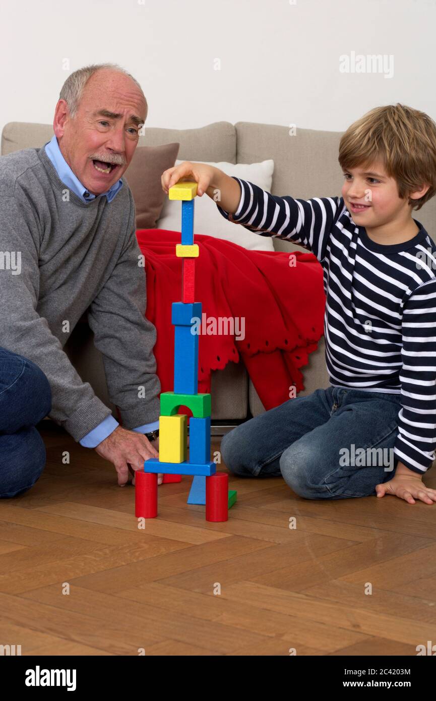 Grandpa grandson build tower hi-res stock photography and images - Alamy