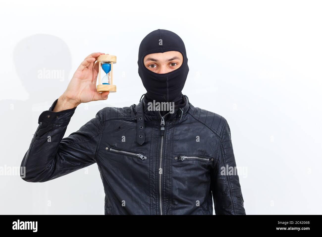 Bandit in black mask with hourglass isolated Stock Photo - Alamy