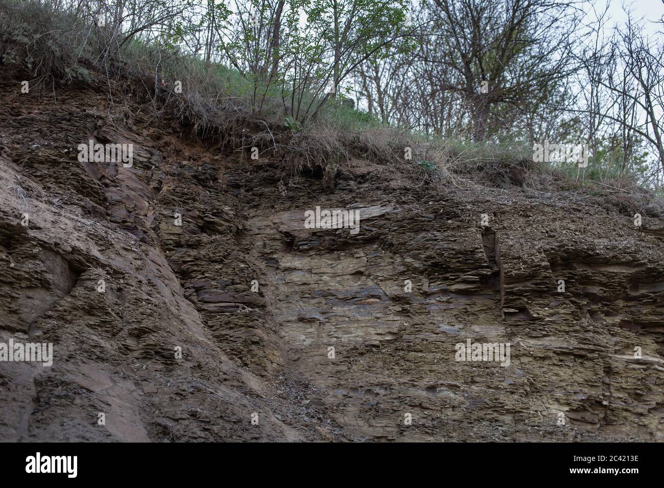 Slope and a limestone cliff. Close-up of a limestone cliff Stock Photo ...