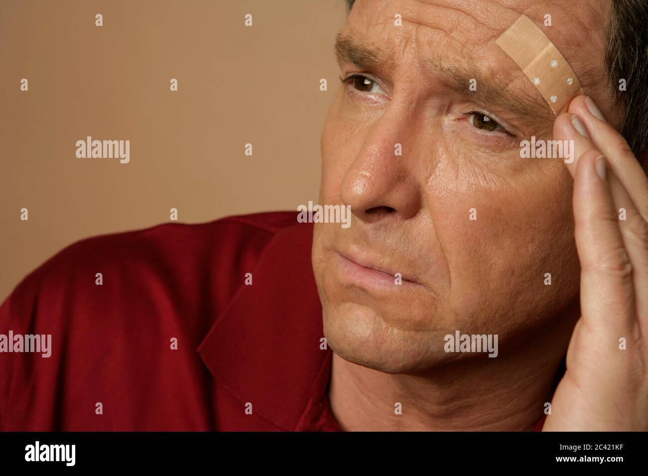 Elderly man with plaster on his forehead Stock Photo - Alamy