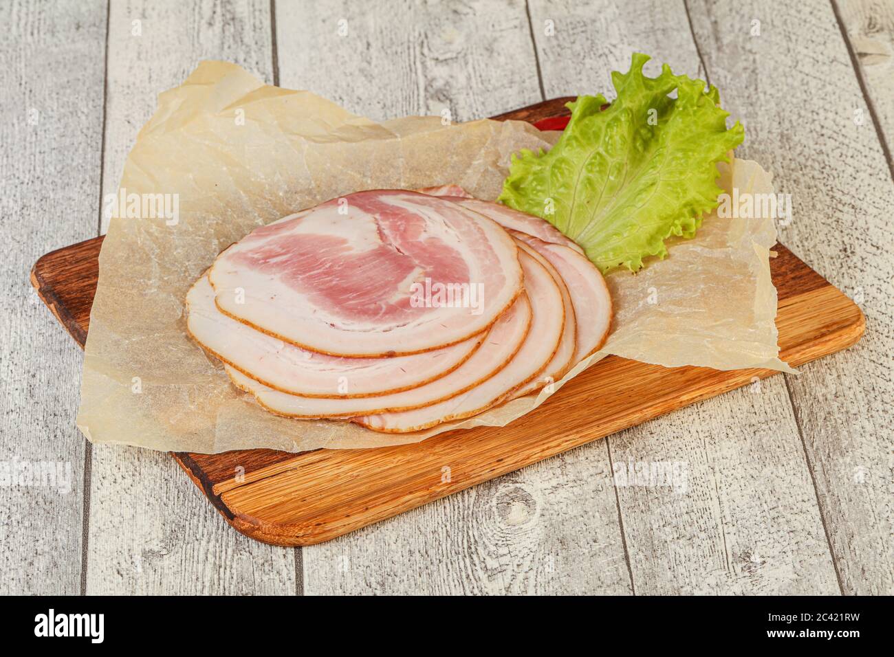 Sliced Italian Pancetta sausage over board Stock Photo - Alamy