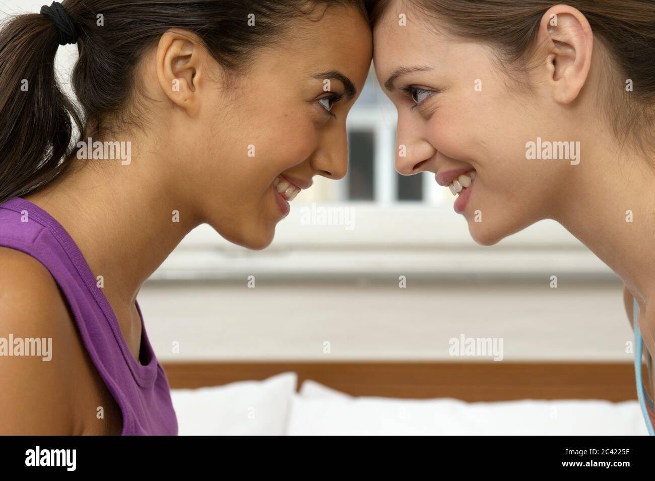 Two young women face to face Stock Photo - Alamy