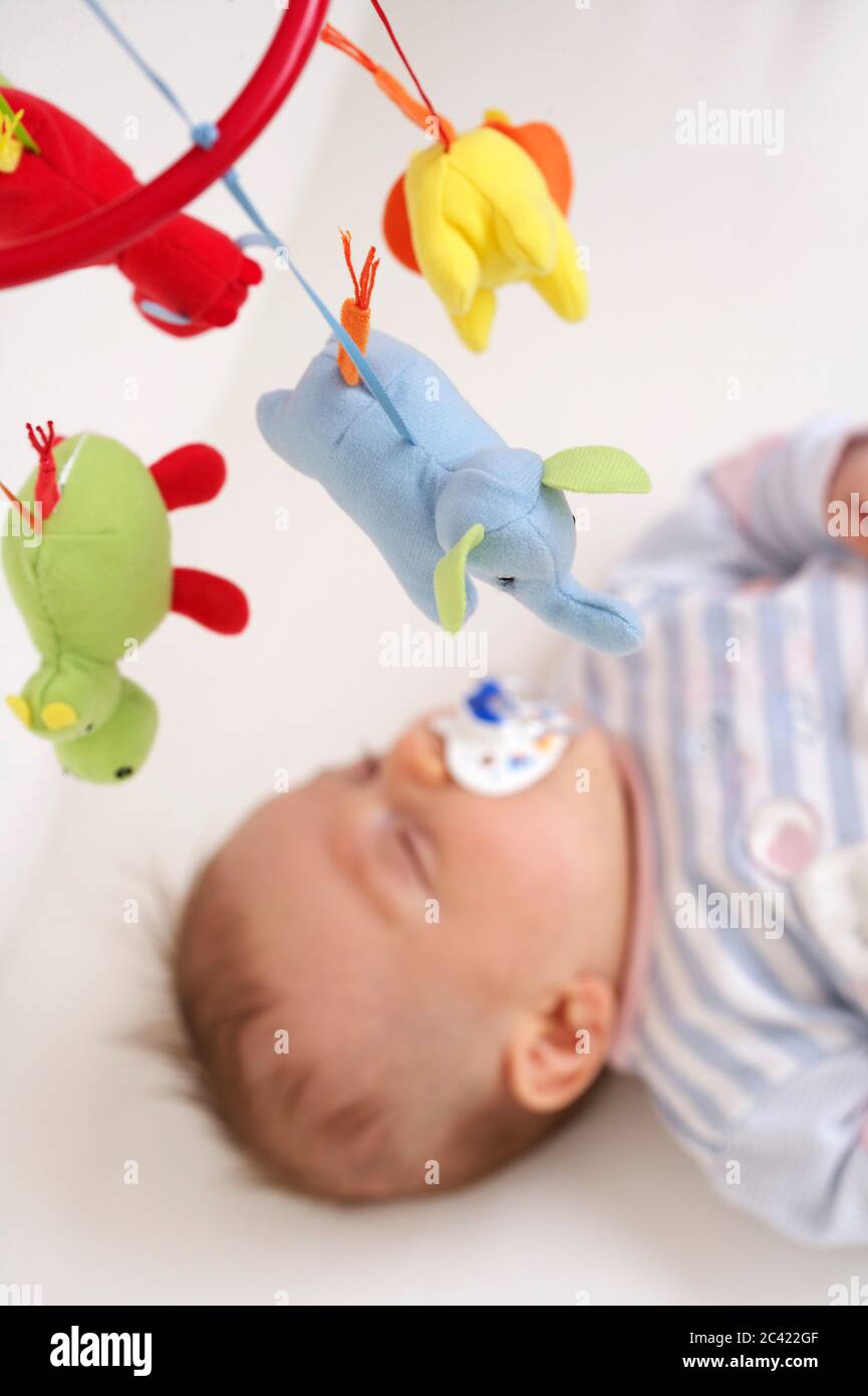 Mobile over sleeping baby Stock Photo - Alamy