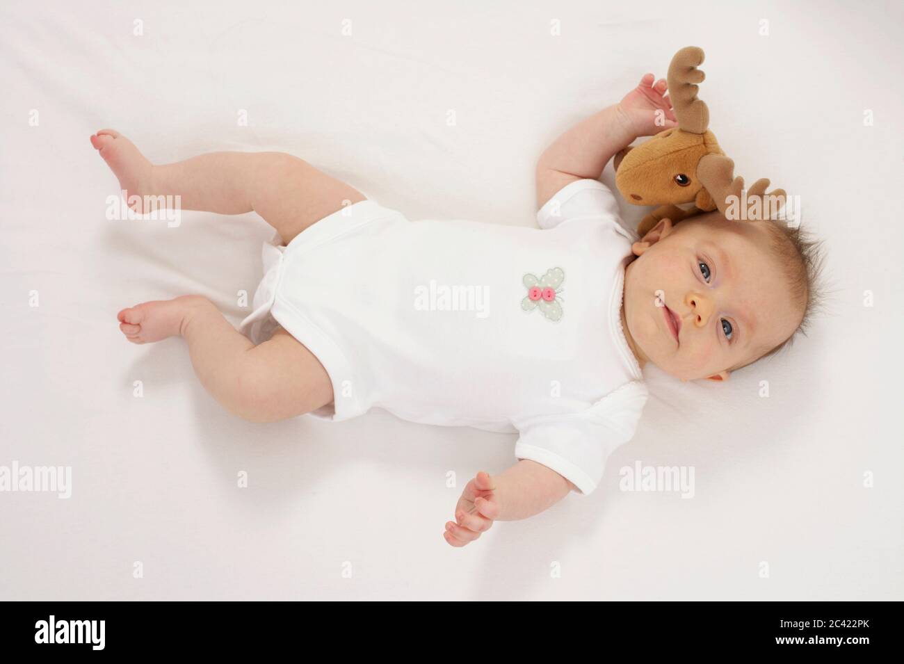 Baby with cuddly toy Stock Photo - Alamy