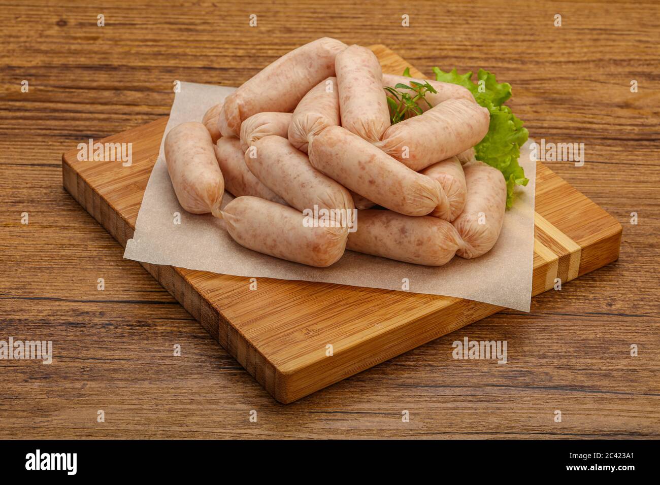 Raw natural chicken baby sausages for roast Stock Photo - Alamy