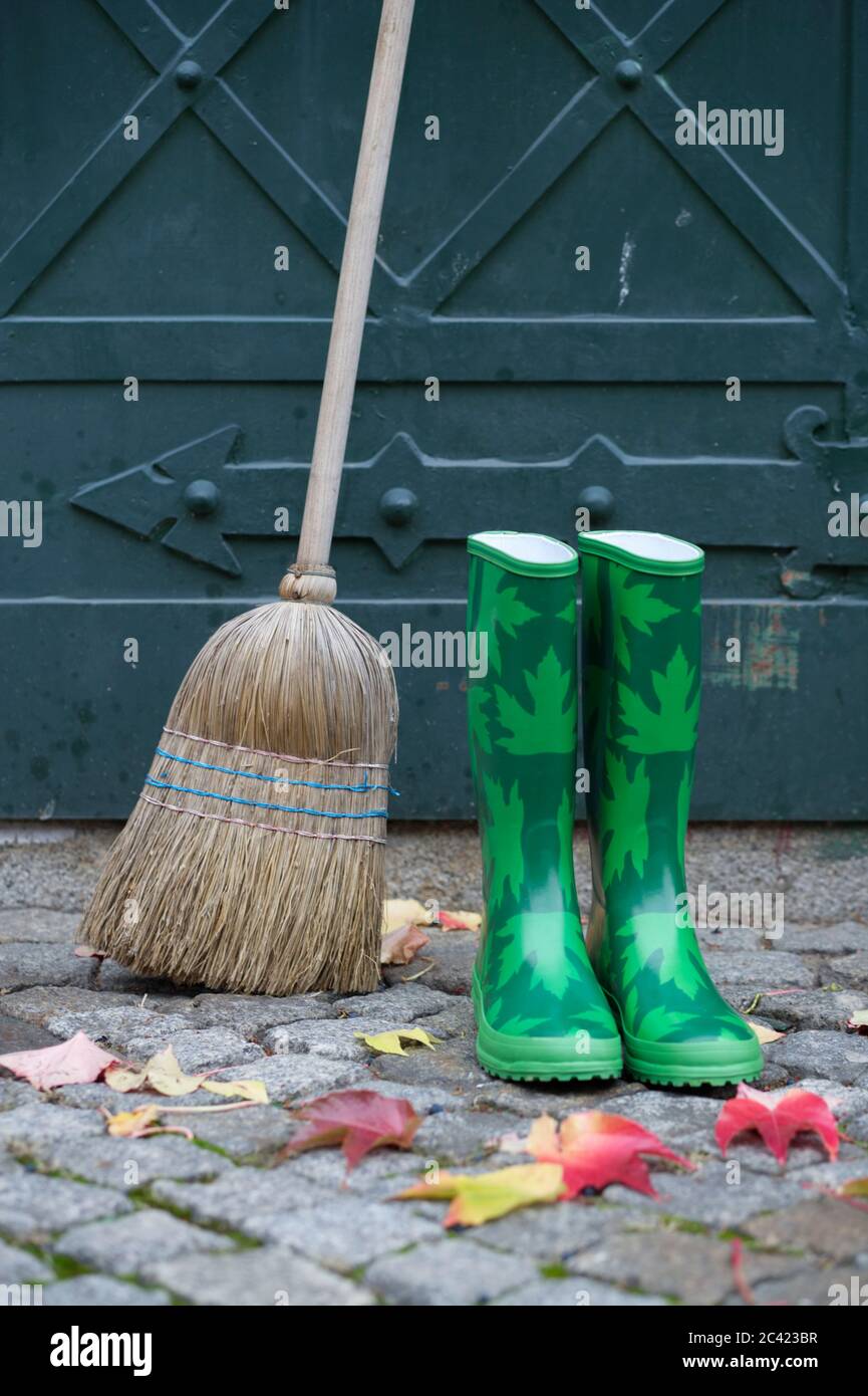 Rubber boots and brooms on pavement Stock Photo - Alamy
