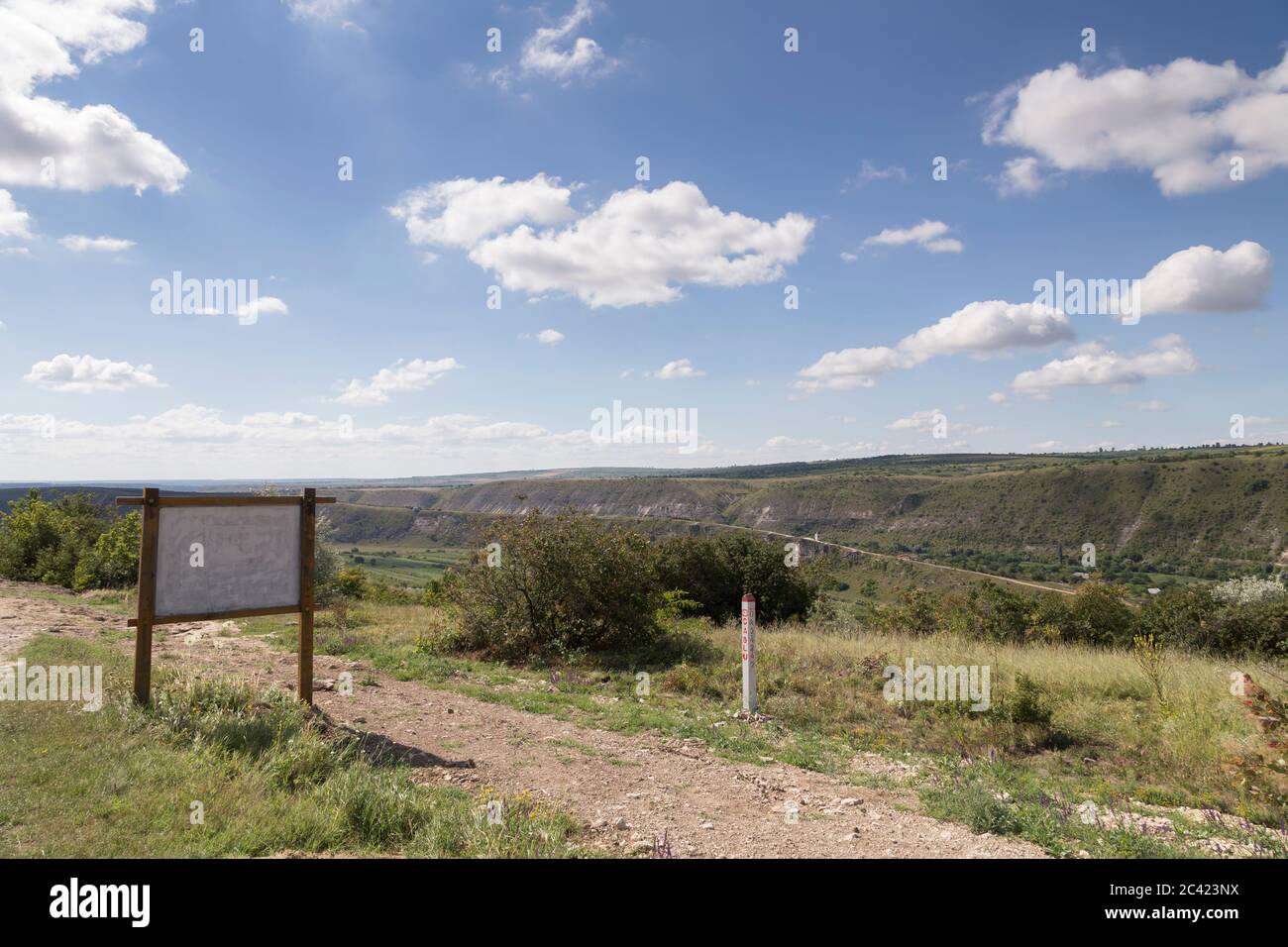 Landscape with signboard. Signboard is near road and there is cloudy ...