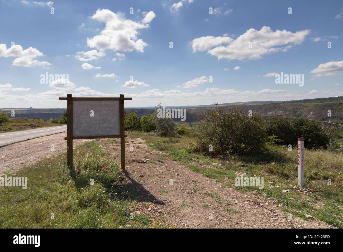 Landscape with signboard. Signboard is near road and there is cloudy ...