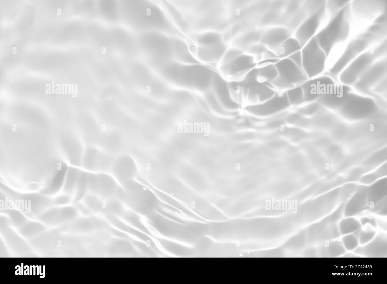 Closeup of desaturated transparent clear calm water surface texture ...