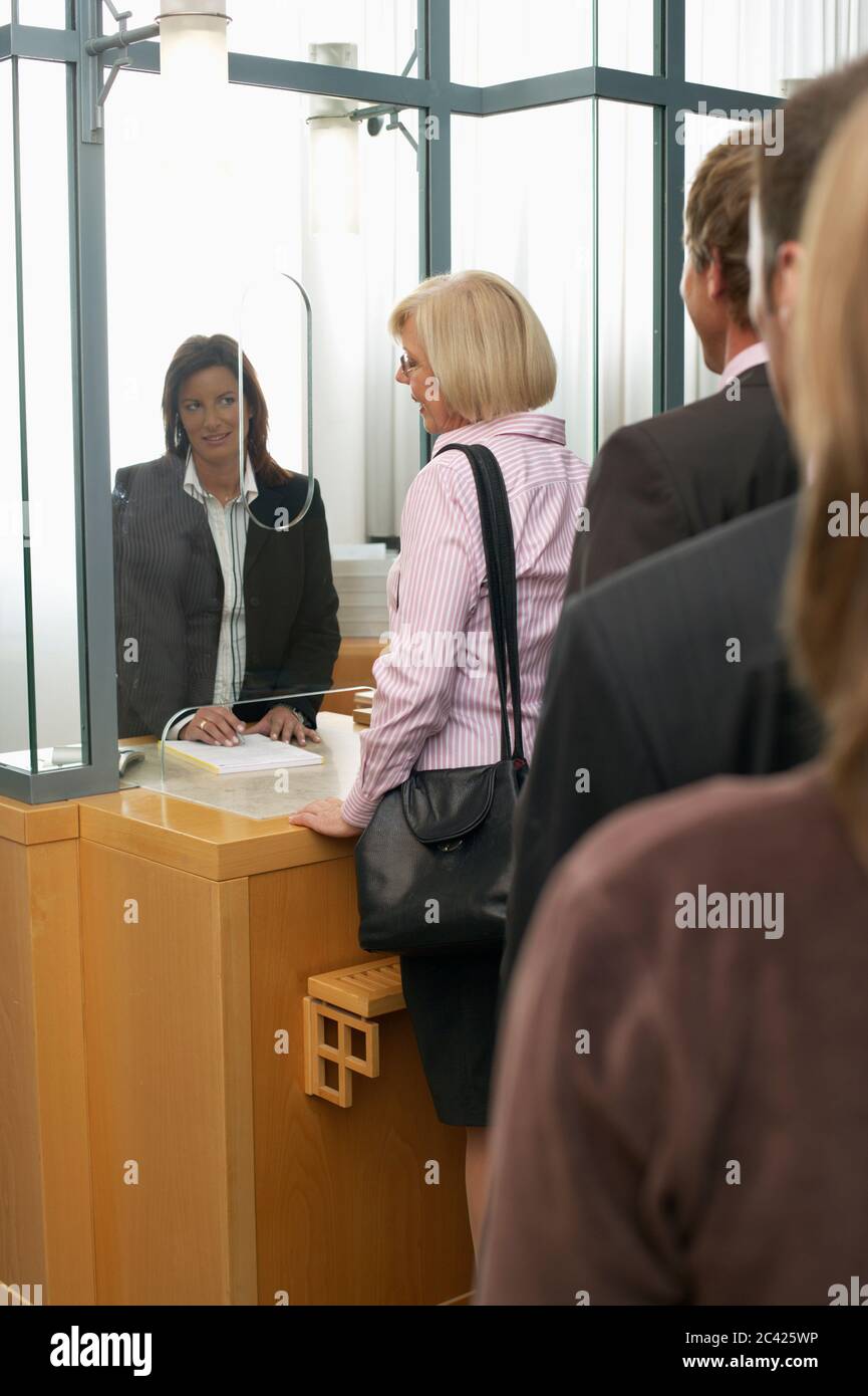 Five people are at a counter - bank Stock Photo - Alamy