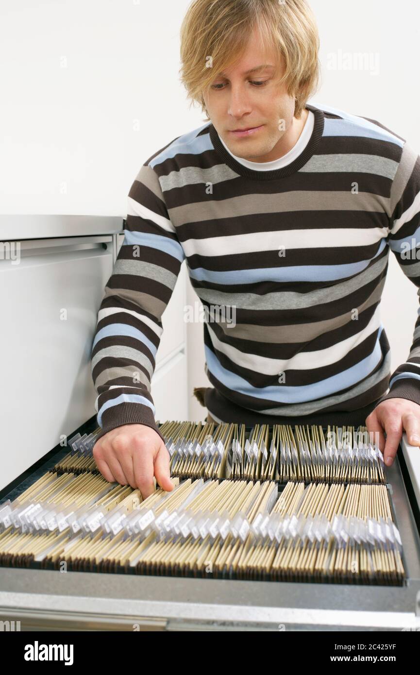 Filing cabinet man hi-res stock photography and images - Alamy