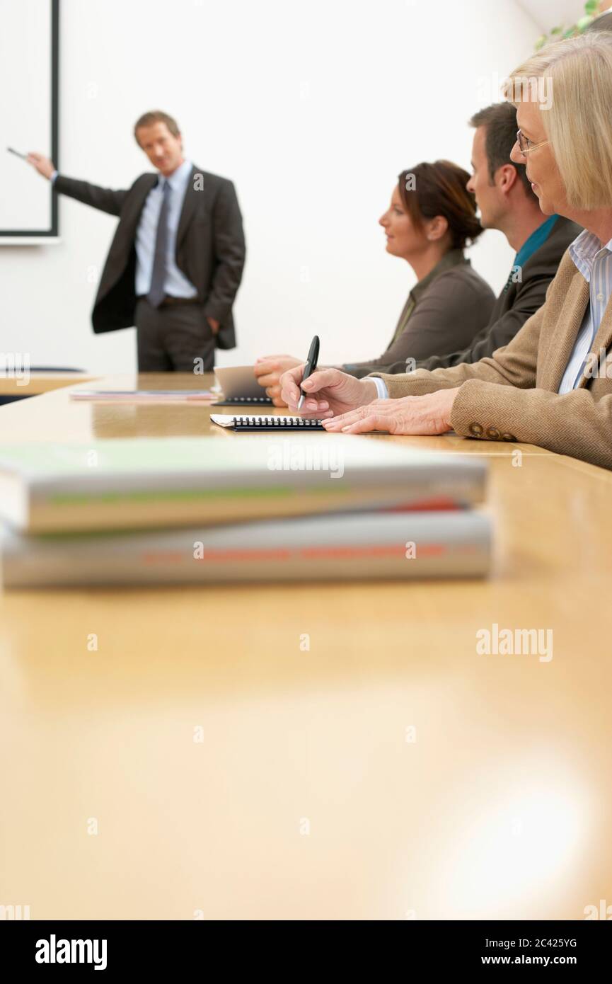 Four people at a presentation - business Stock Photo - Alamy