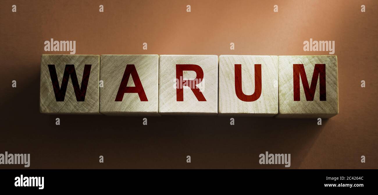 Wooden cubes showing the German word for Why, German: Warum . Cause ...