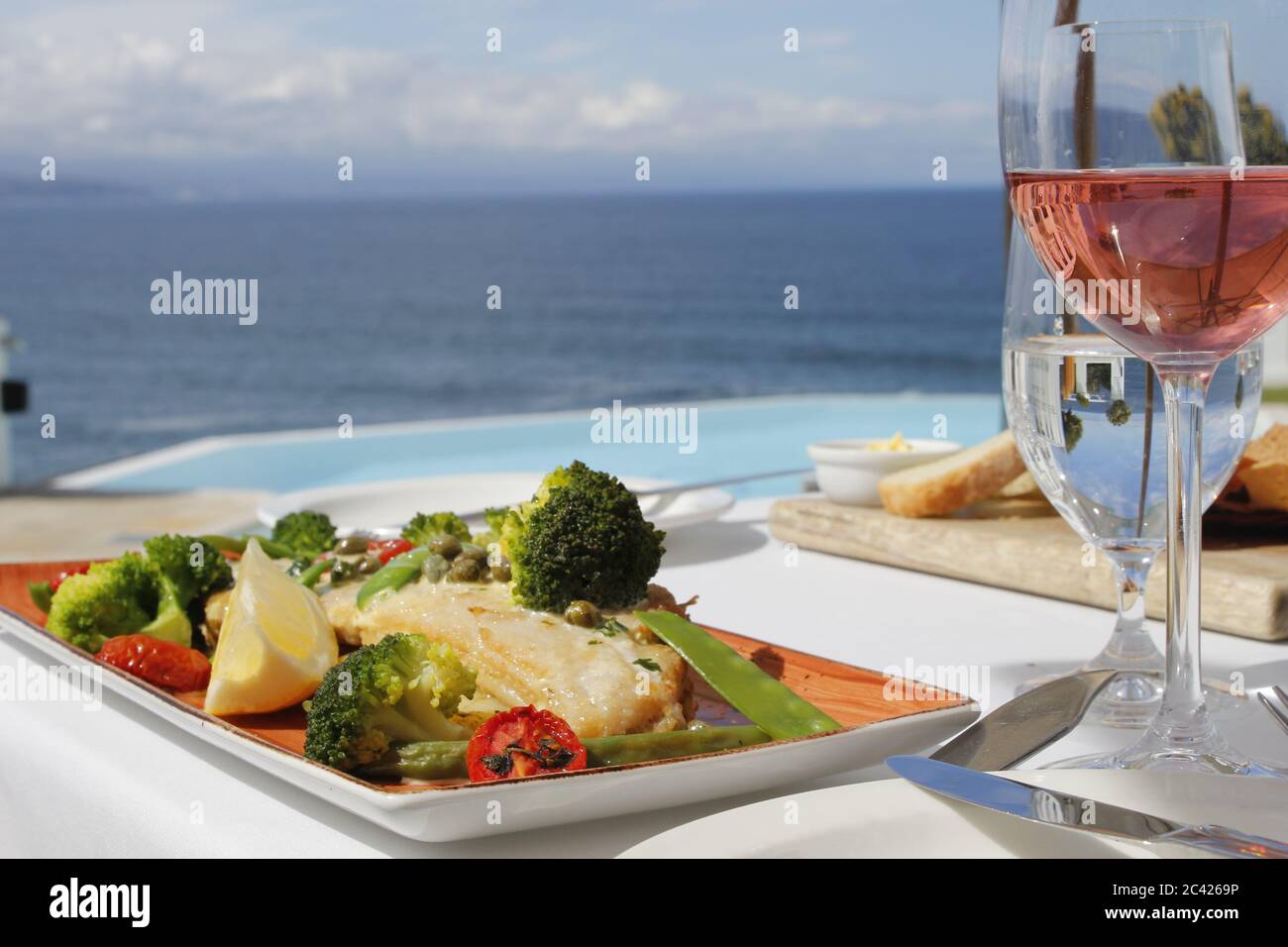 Luxury lunch in an outdoor restaurant in the sunshine with a glass of ...