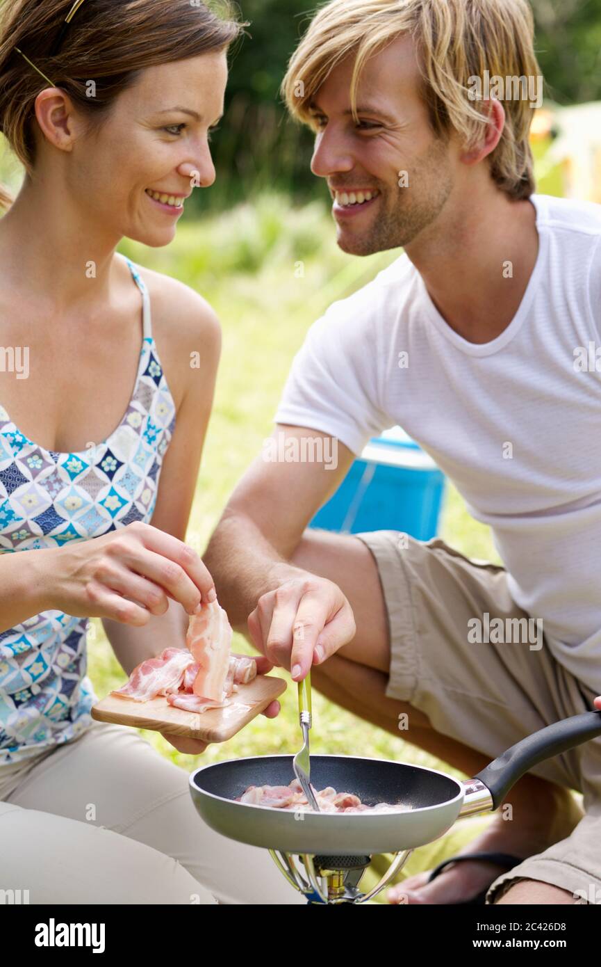 Young couple cooks outdoors Stock Photo - Alamy