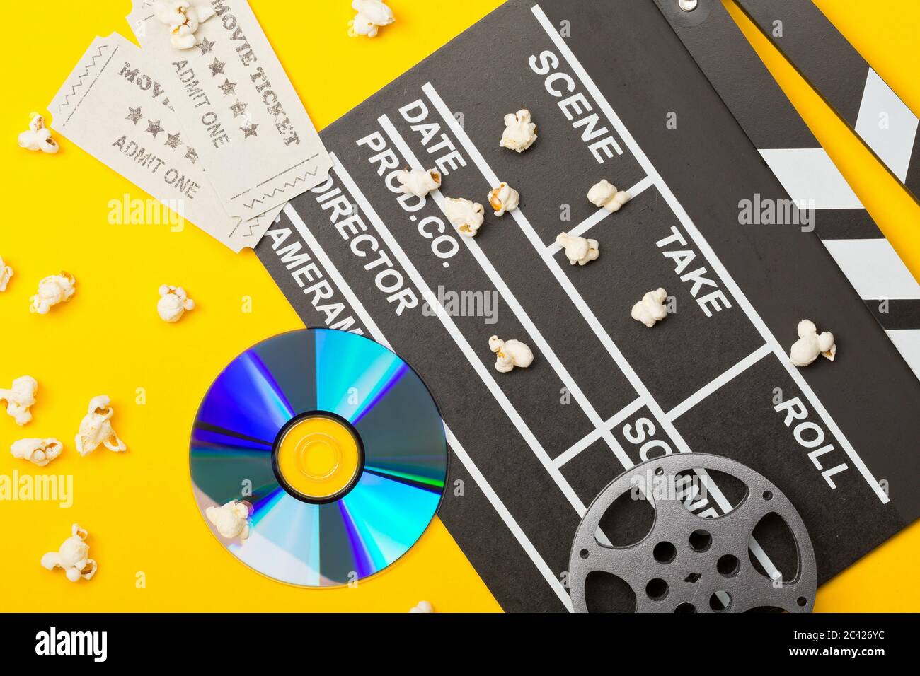 Single, black, open movie clapper or clapper-board with dvd movie disc ...