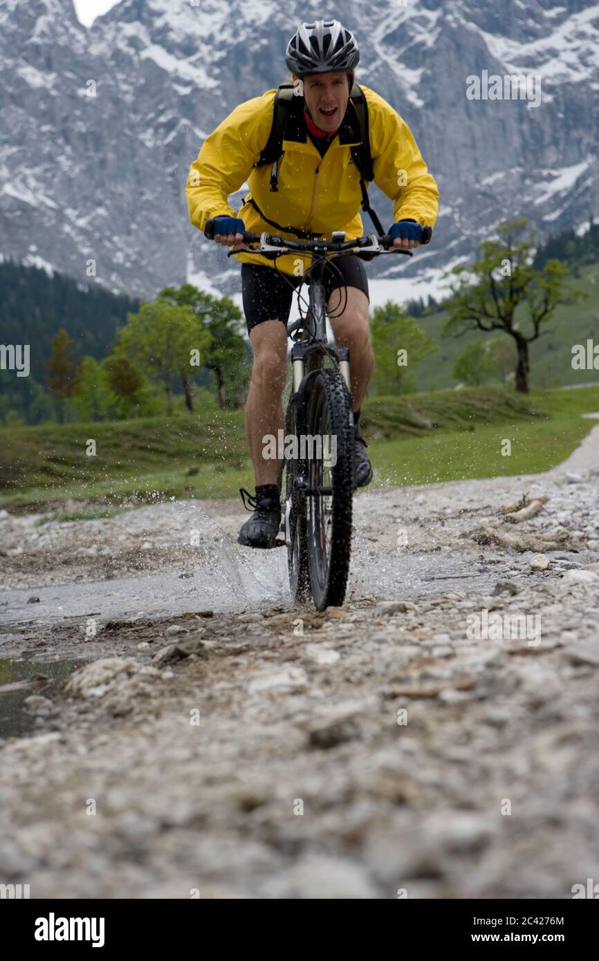 Mountain bikers drive through the terrain Stock Photo - Alamy