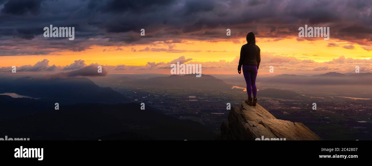 Fantasy Adventure Photo with a Girl on top of a Rock Cliff Stock Photo ...