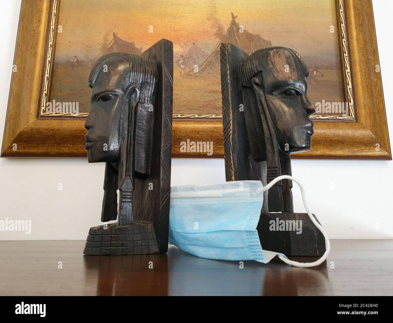 African head sculptures and surgical mask decor. Indoor home isolation ...