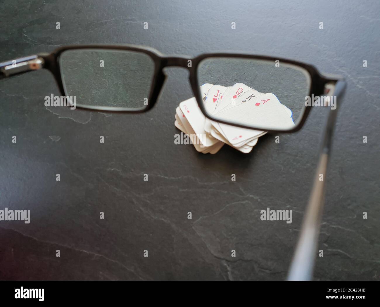 Glasses and deck of poker cards on table as symbol for gambling. Indoor ...