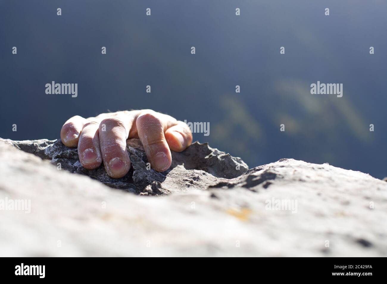Hand pulls up a rock - strength - climbing Stock Photo - Alamy