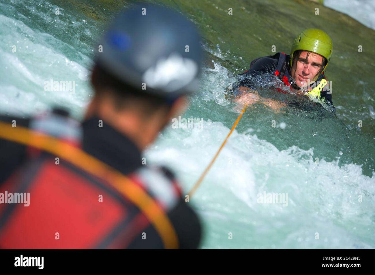 Man in wetsuit and helmet rescues another man from torrential floods ...