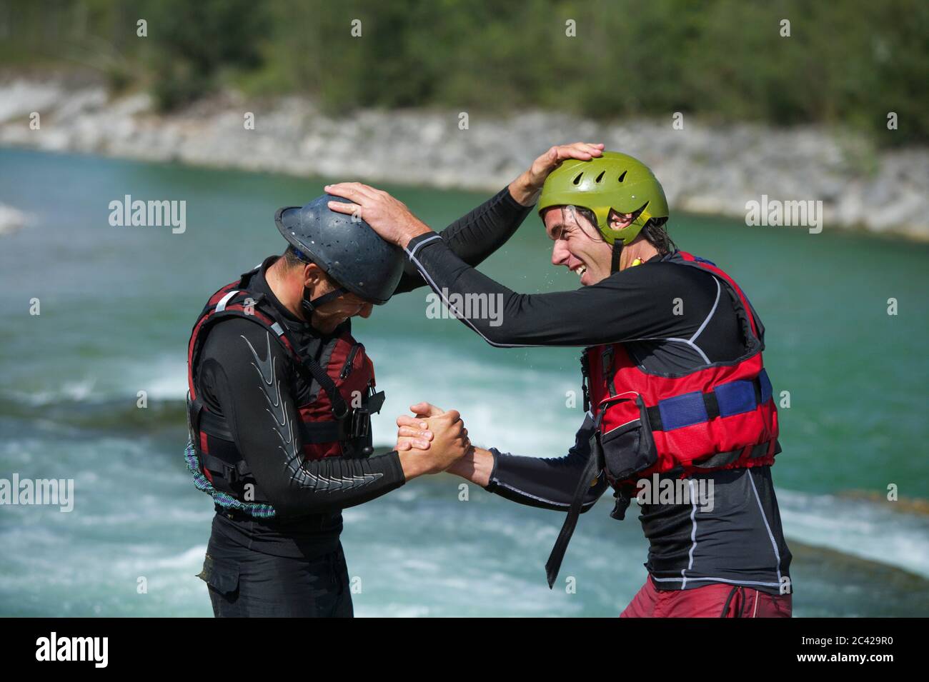 Two men in wetsuits make a handshake - friends - success - white water ...