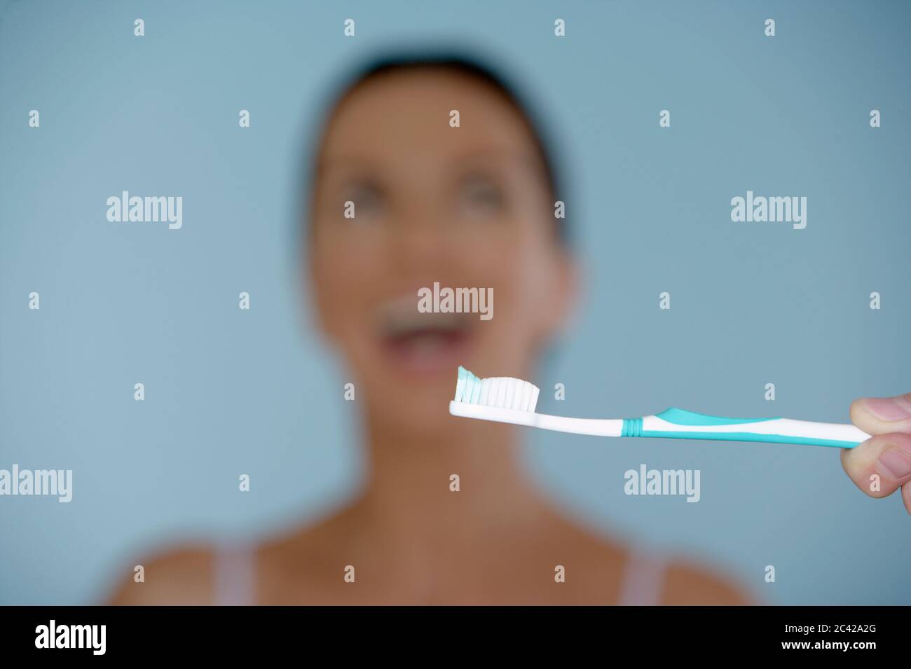 Hand with toothbrush in front of a woman's silhouette - hygiene Stock ...