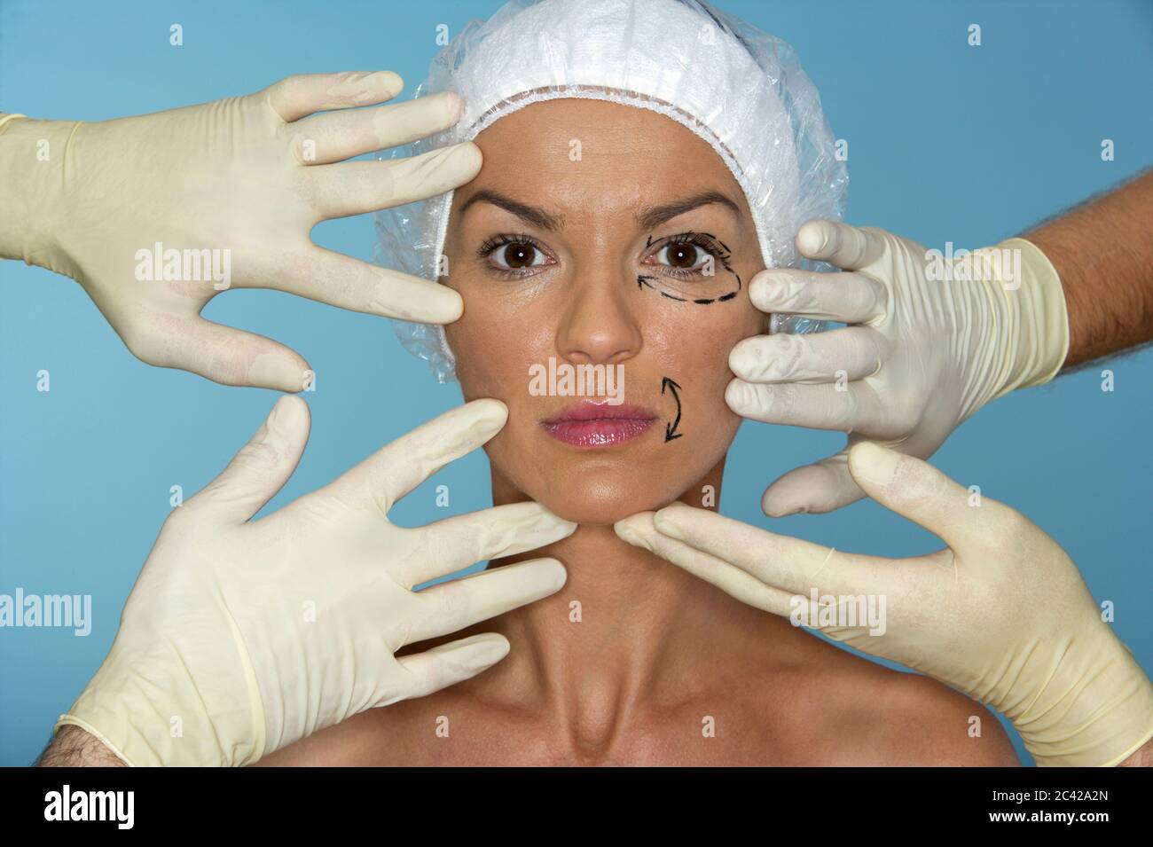 Young woman with an arrow mark on the corner of her mouth and eyelid ...