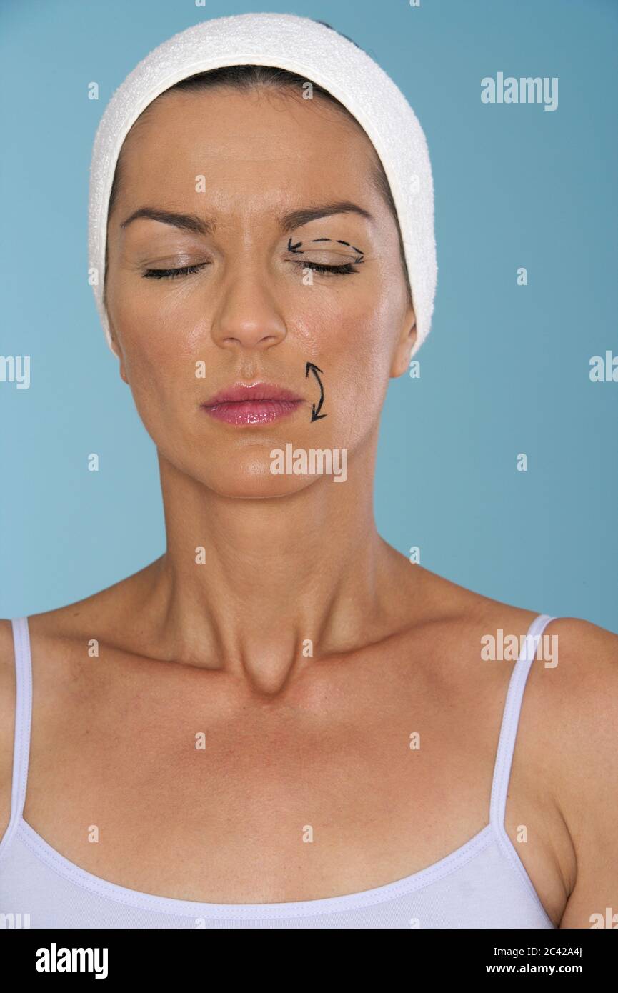 Young woman with an arrow mark at the corner of her mouth - cosmetic ...