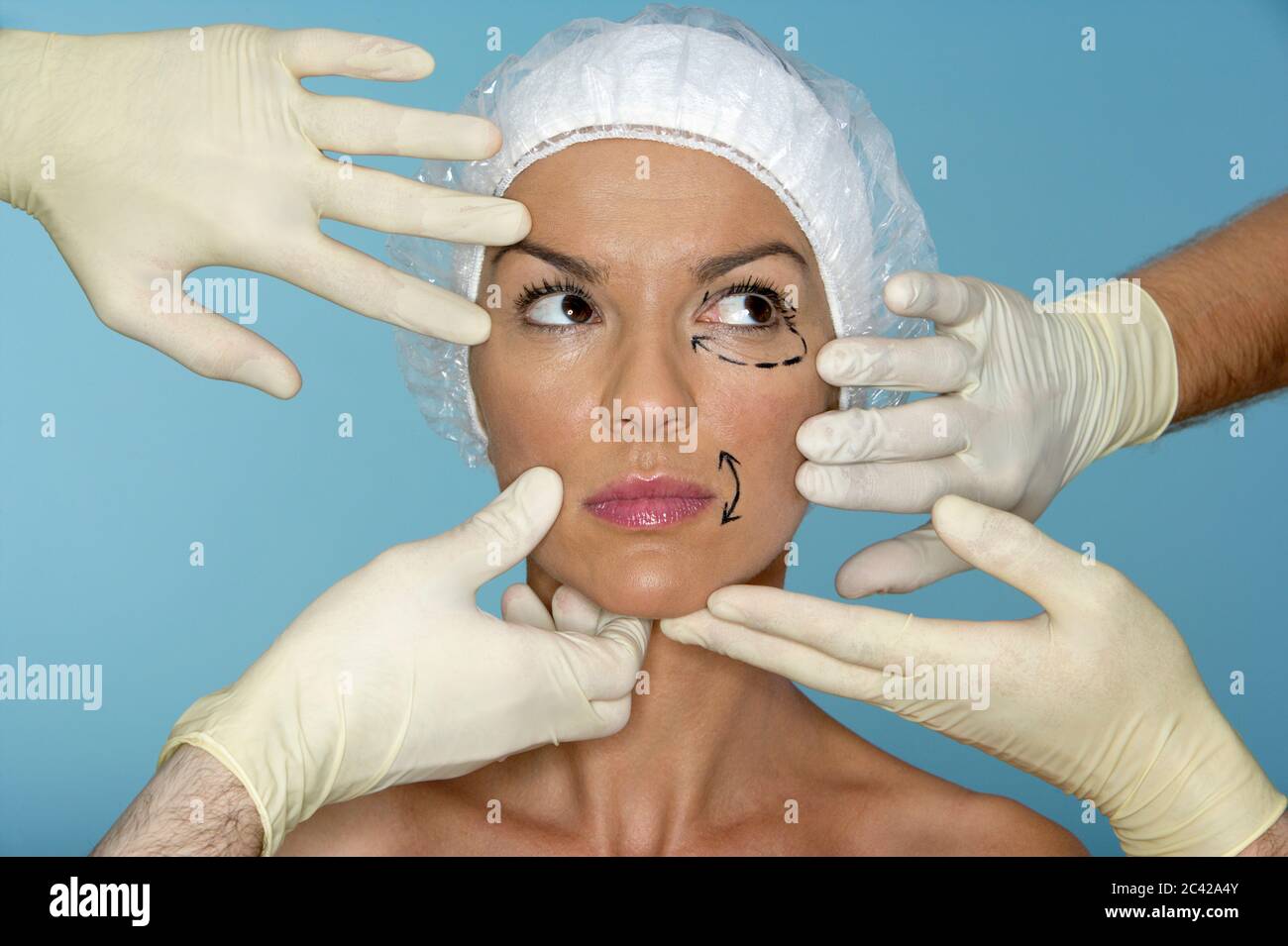 Young woman with an arrow mark on the corner of her mouth and eyelid ...
