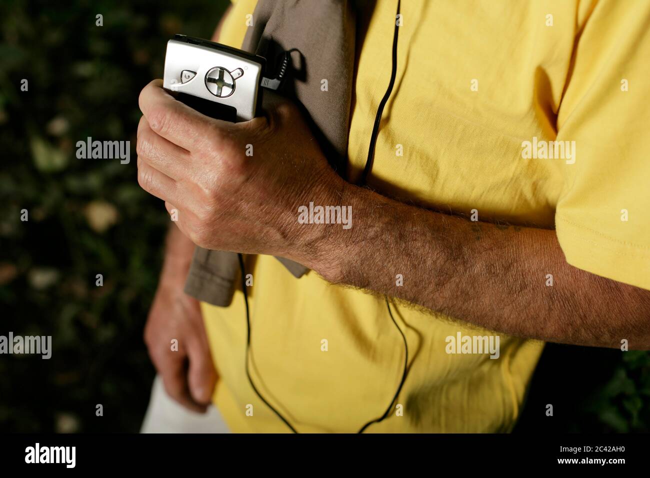 Old man holds MP3 player in his hand Stock Photo - Alamy