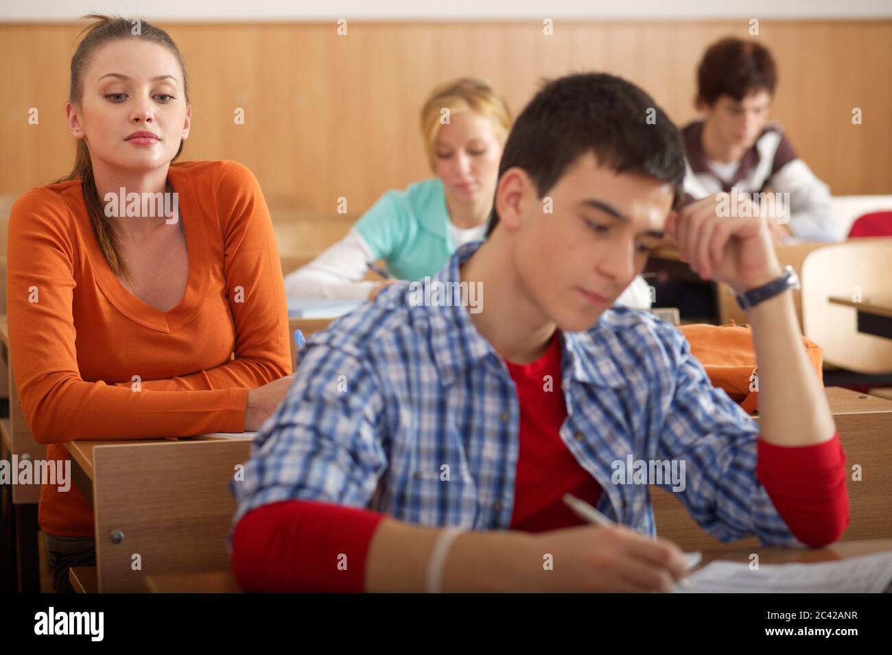 Students at tables in a classroom - exam Stock Photo - Alamy
