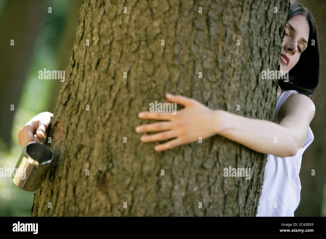 Tree hugging young woman arms hi-res stock photography and images - Alamy