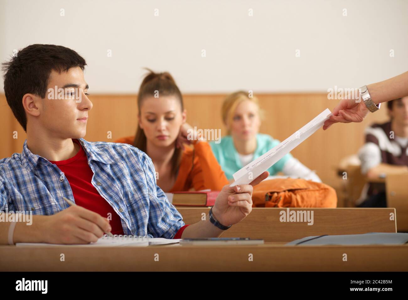 Students at tables in a classroom - exam Stock Photo - Alamy
