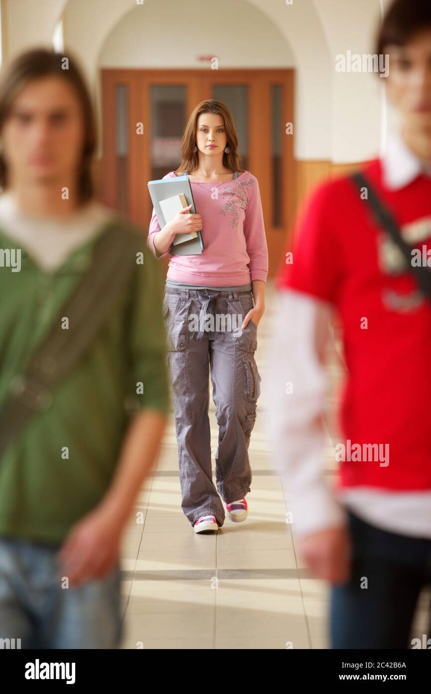 Brunette girl walks down the hall - teenage school Stock Photo - Alamy