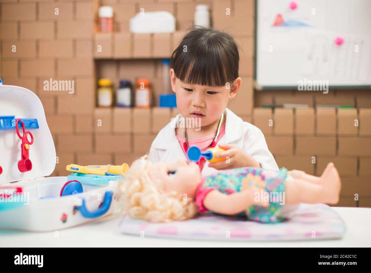 toddler girl pretend play doctor role at home Stock Photo - Alamy