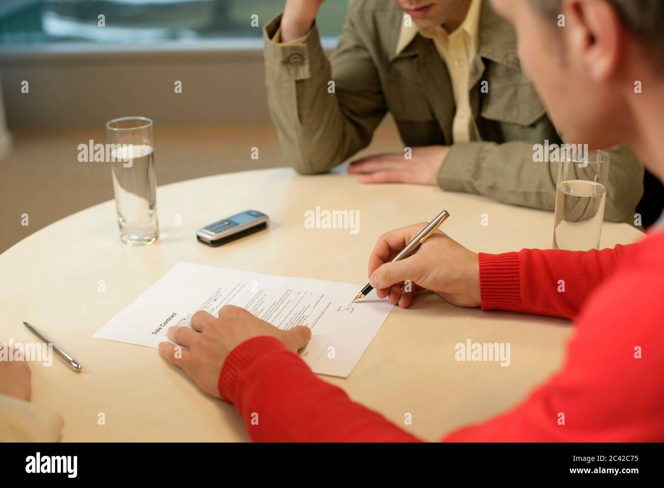 Man signs document Stock Photo - Alamy