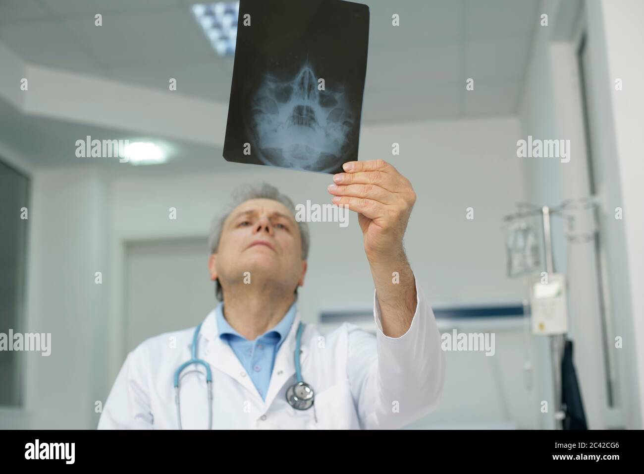Surgical doctor in sterile clothes looks at an x-ray - profession Stock ...