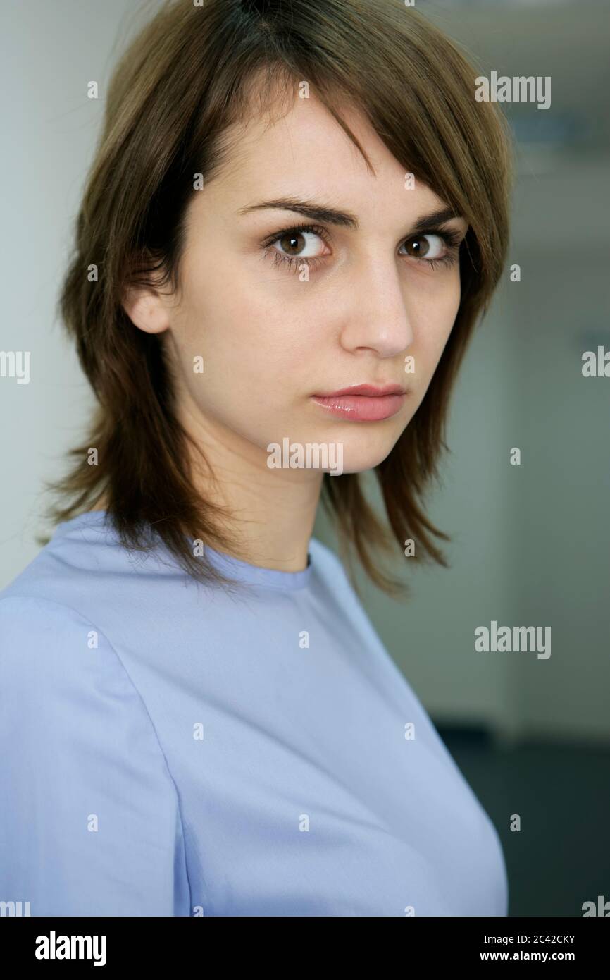 Brunette woman in a hospital shirt in the hallway - patient ...